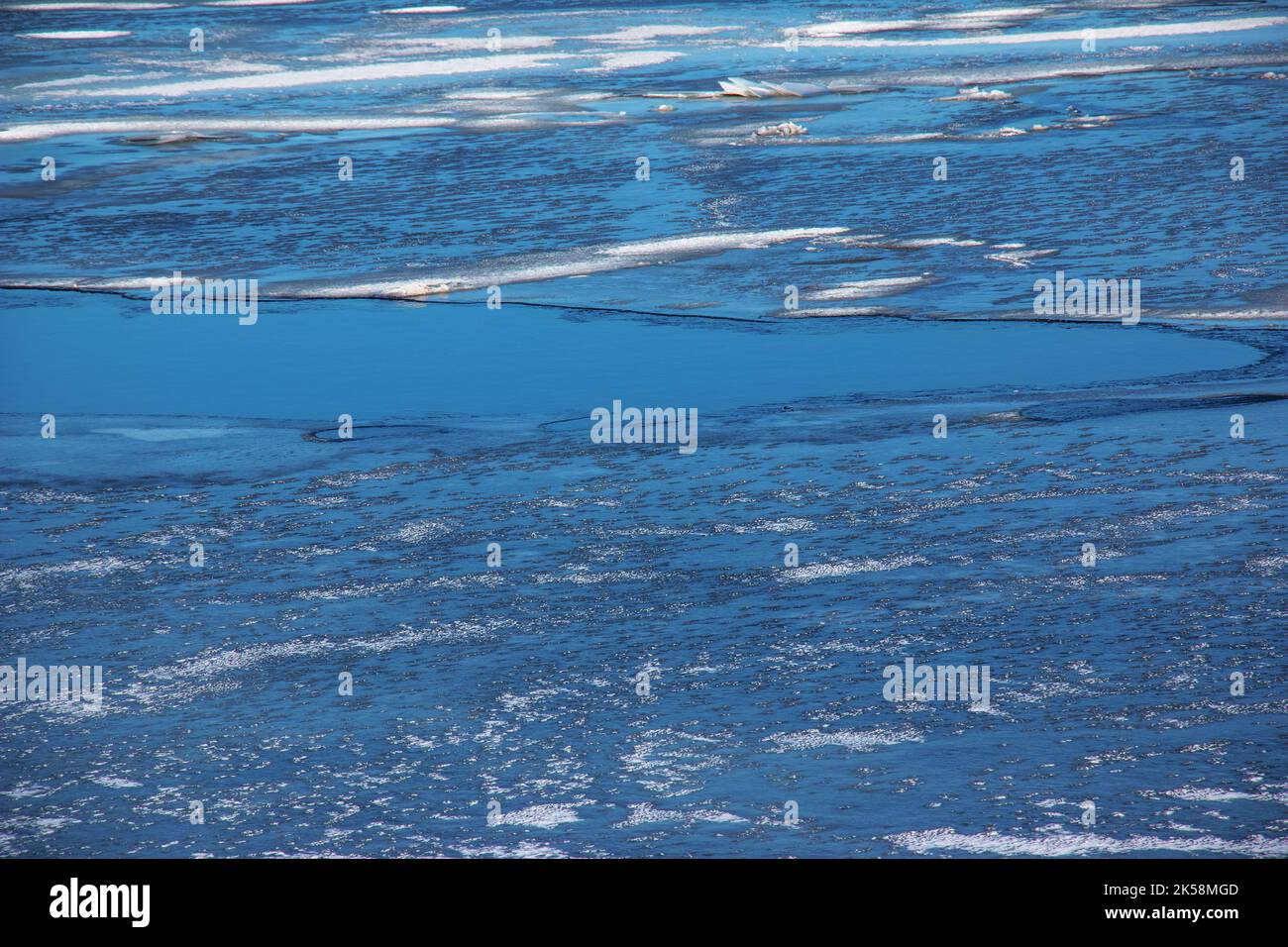 Winter nature background with blocks of ice on frozen water in spring ...