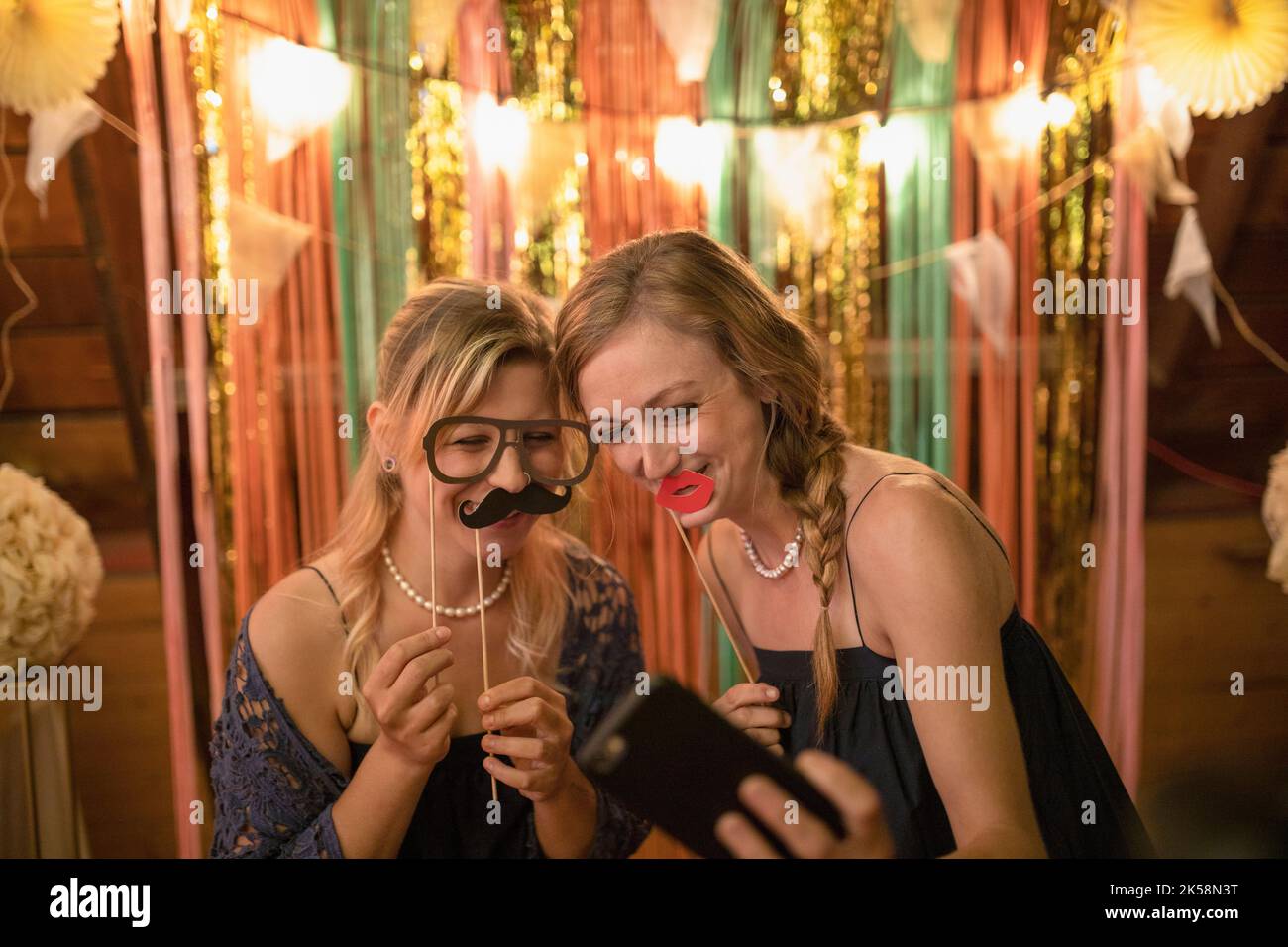 Two young people standing photo booth hi-res stock photography and ...