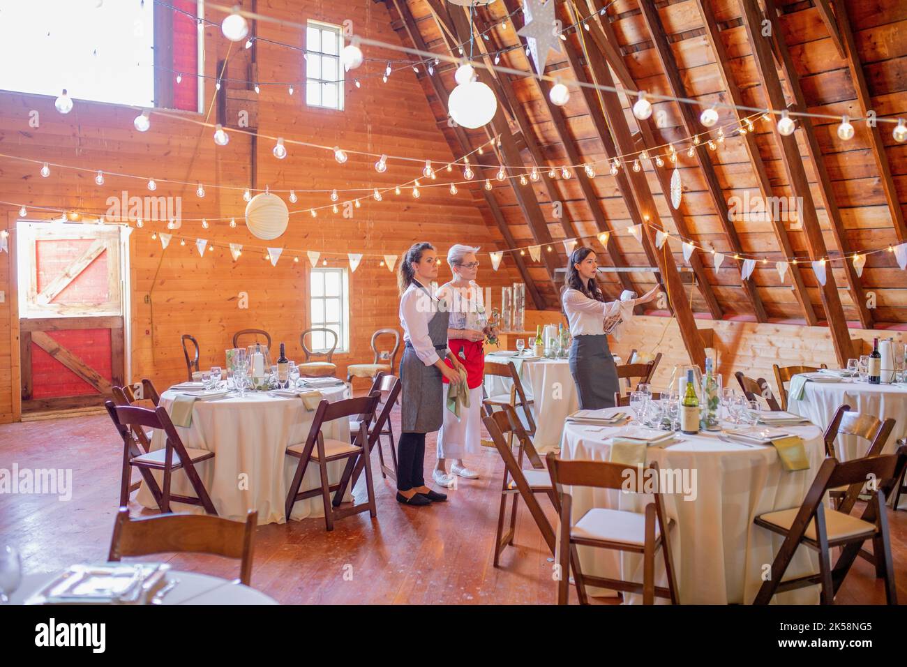 Preparing for wedding reception in barn hi-res stock photography and ...