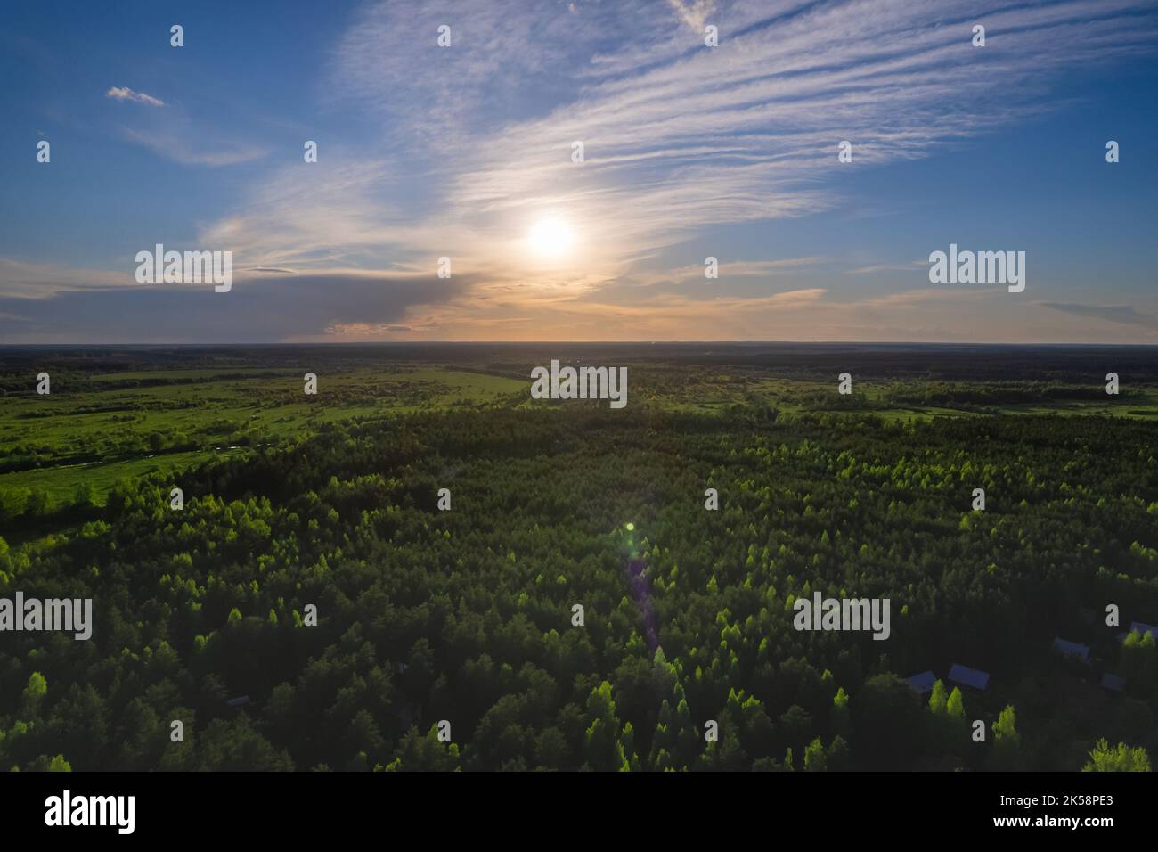 Sunrise over green forest. Aerial shot. Direct sun with lens flare ...