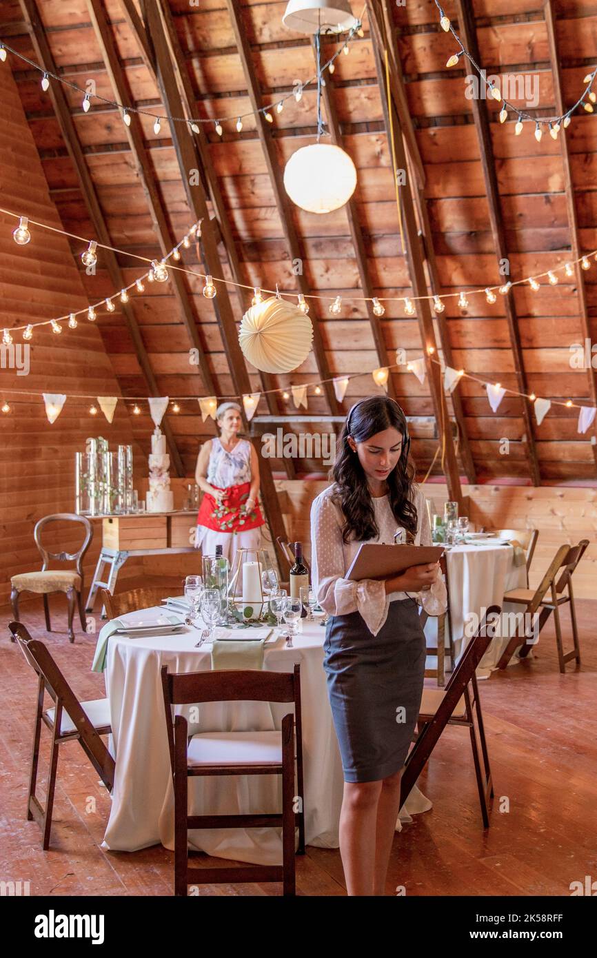 Preparing for wedding reception in barn hi-res stock photography and ...