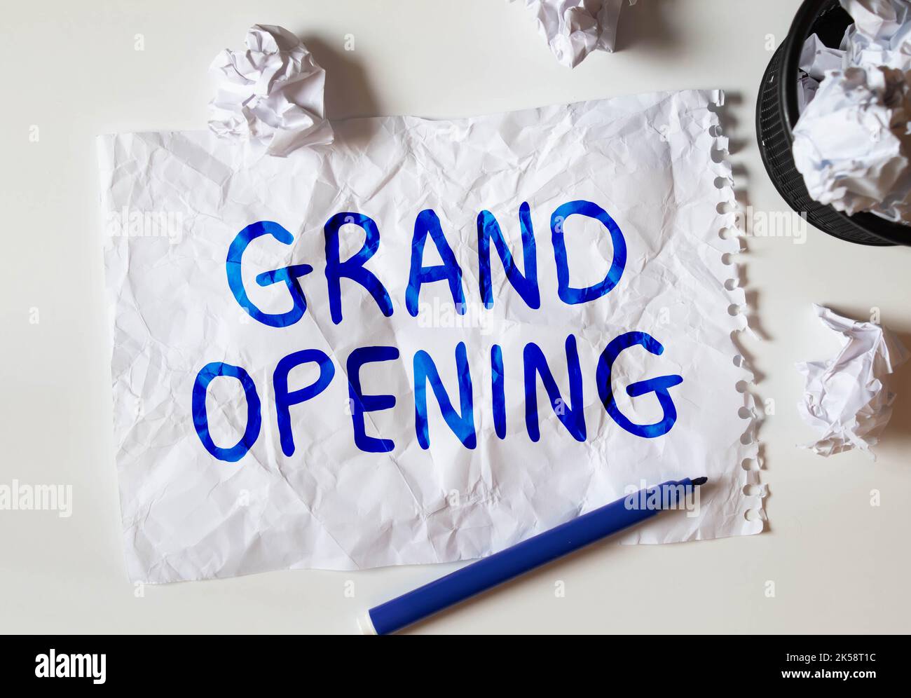 Painter hanging from harness painting a wall with the words Grand ...