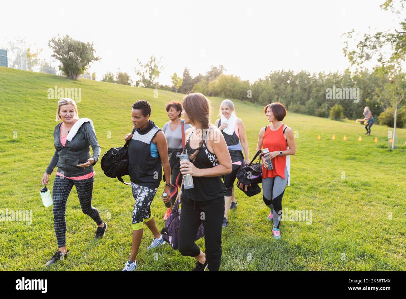 Group of women walking on grass after bootcamp Stock Photo - Alamy