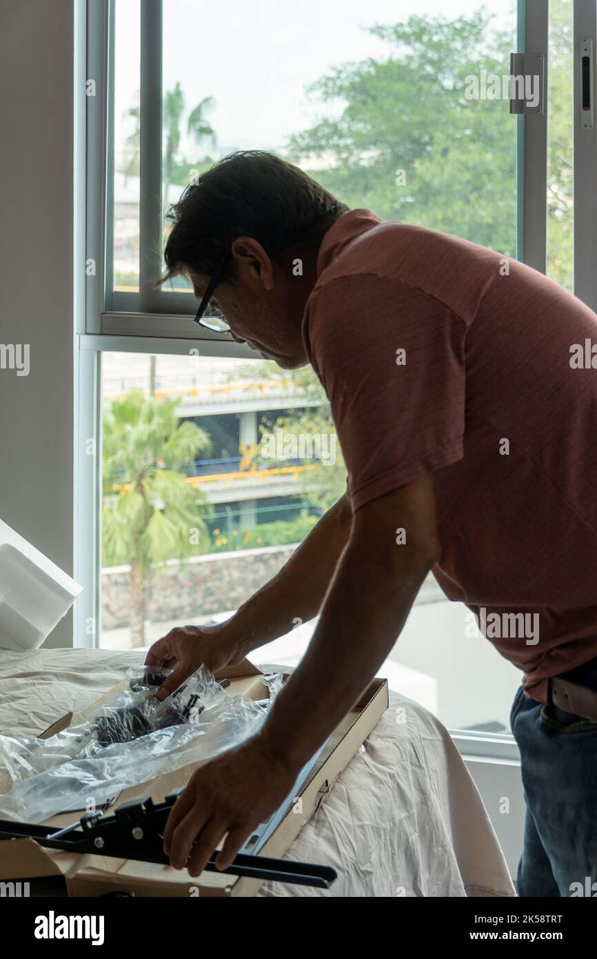 latino man looking for tools in his toolbox, hispanic, with screwdriver ...