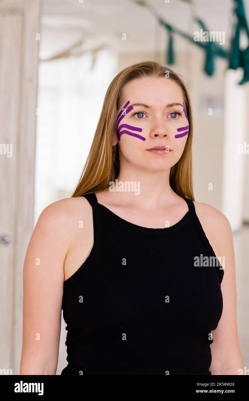 woman 30 -40 years old applying lifting tape . concept of facial ...