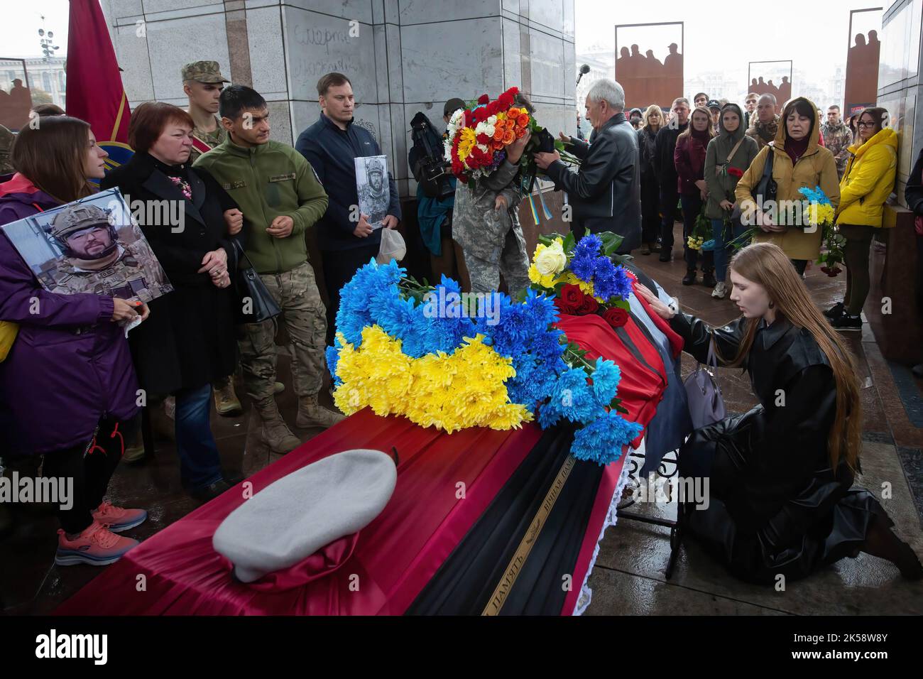 Ukrainian soldiers and relatives mourn at the coffin with the body of ...