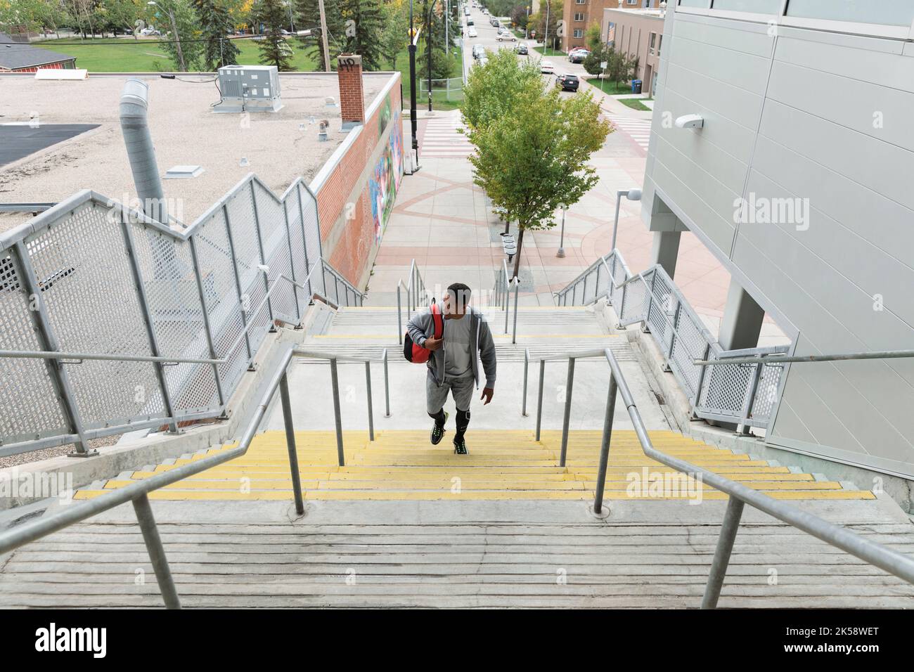 Man climbing up steps hi-res stock photography and images - Alamy