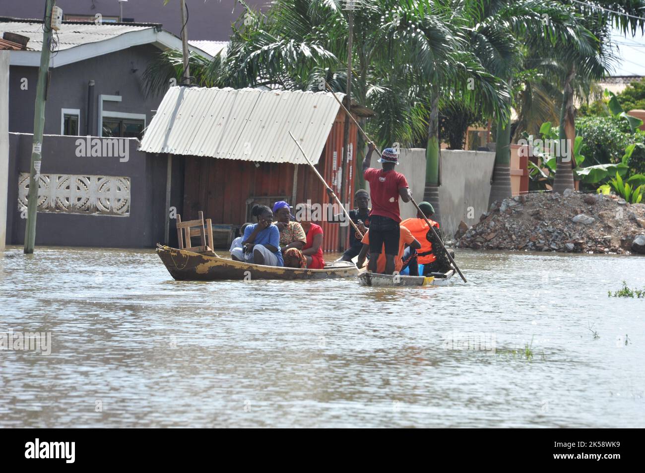 Accra, Ghana. 5th Oct, 2022. People travel in canoes in a flooded area ...