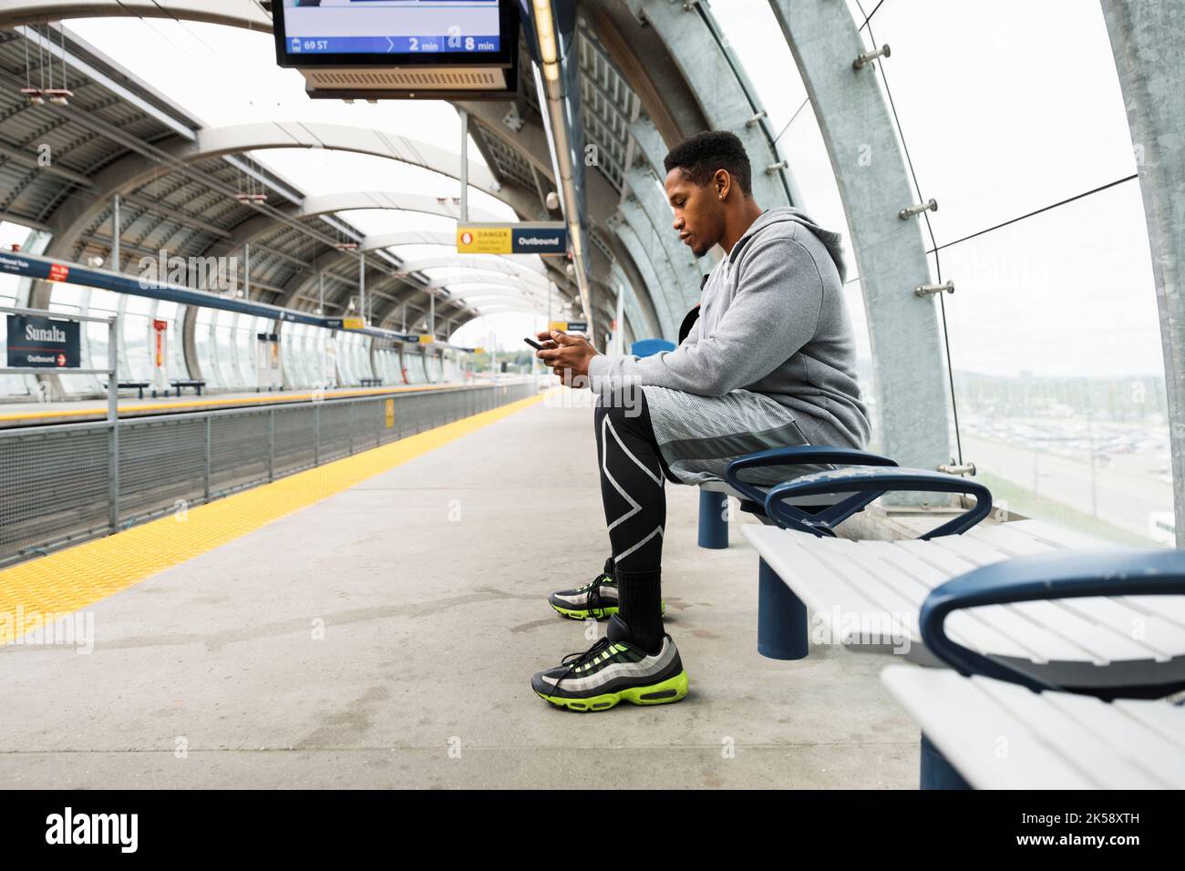 Sitting man train station hi-res stock photography and images - Alamy