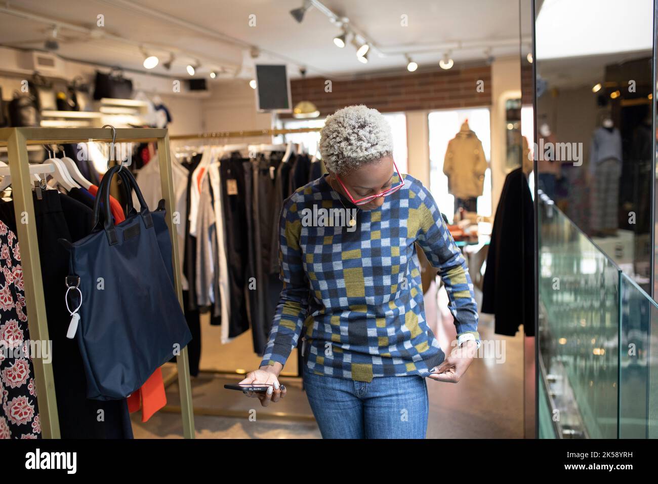 Woman trying on new clothes hi-res stock photography and images - Alamy