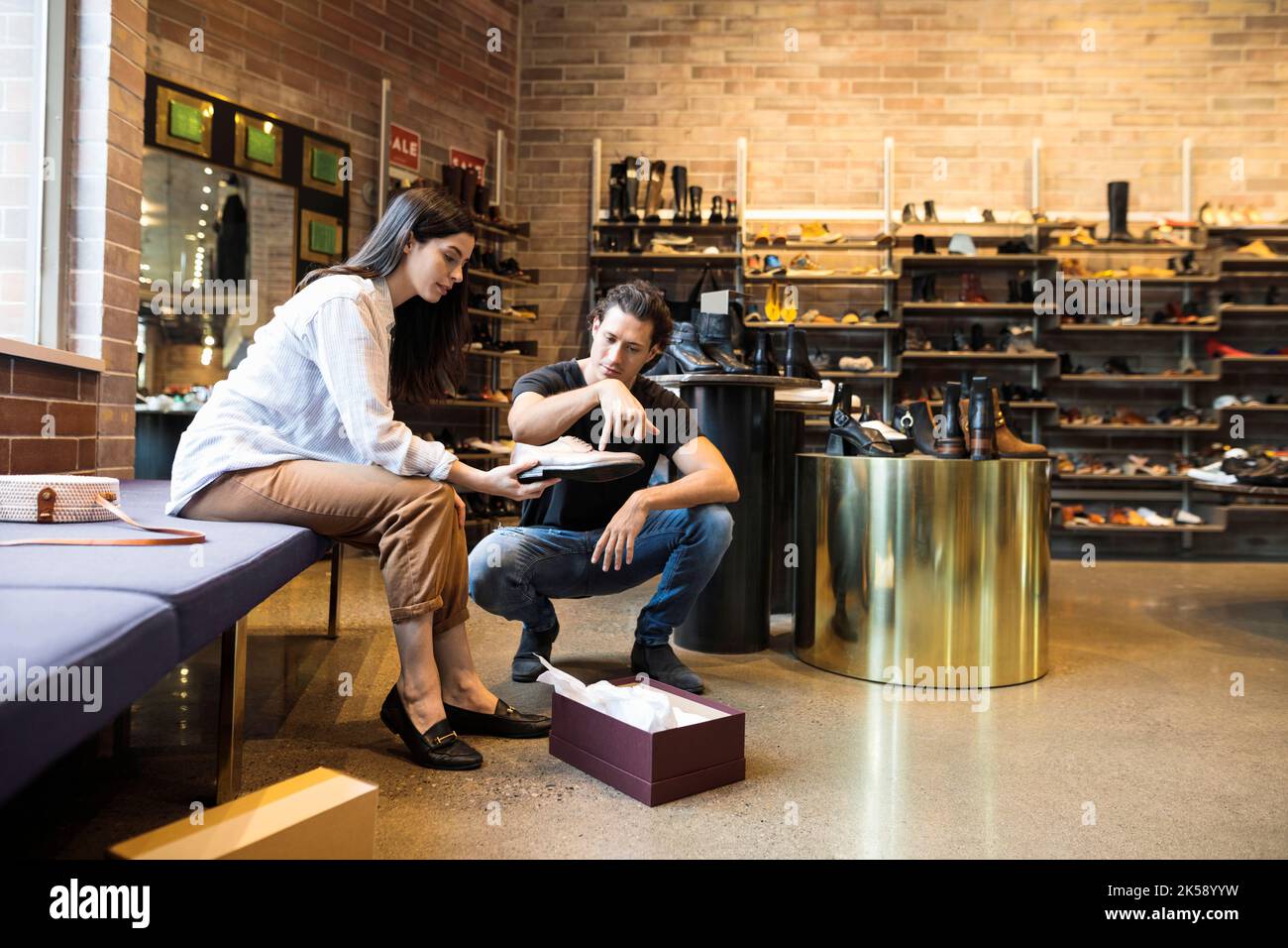 Women talking to shop assistant hi-res stock photography and images - Alamy