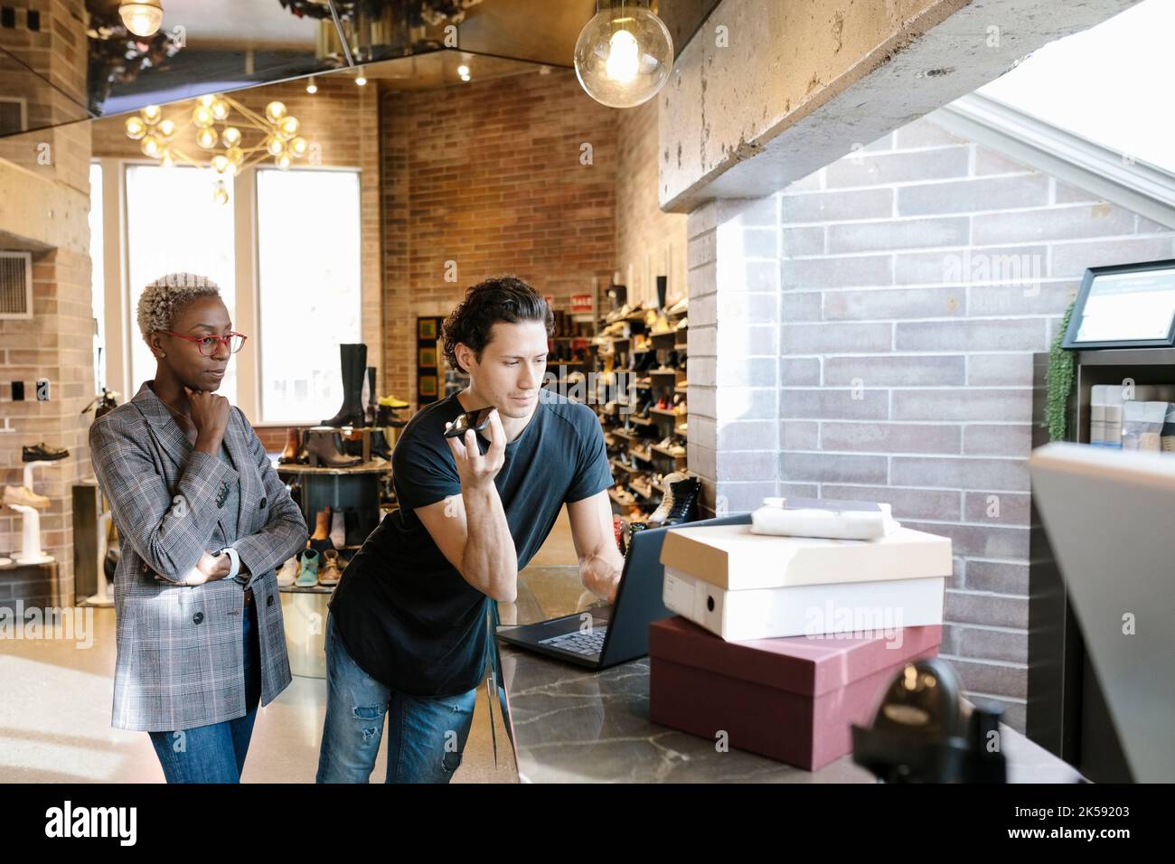 Shop assistant helping shoe box hi-res stock photography and images - Alamy