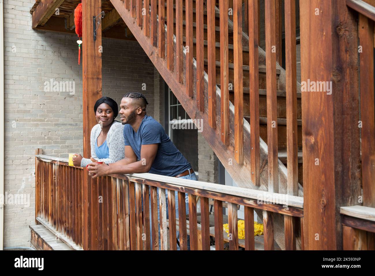 Two people talking on balcony hi-res stock photography and images - Alamy