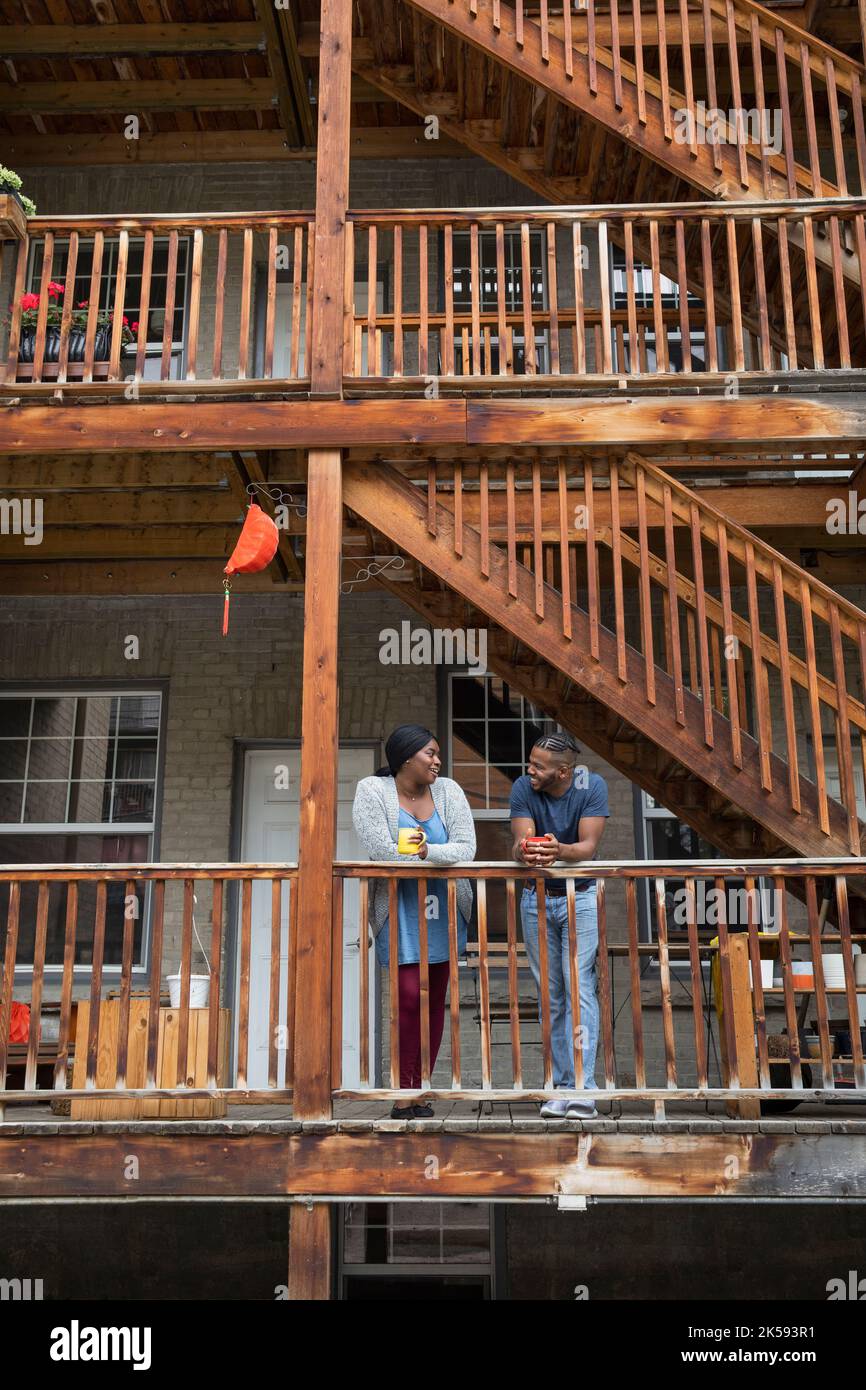 Two people talking on balcony hi-res stock photography and images - Alamy