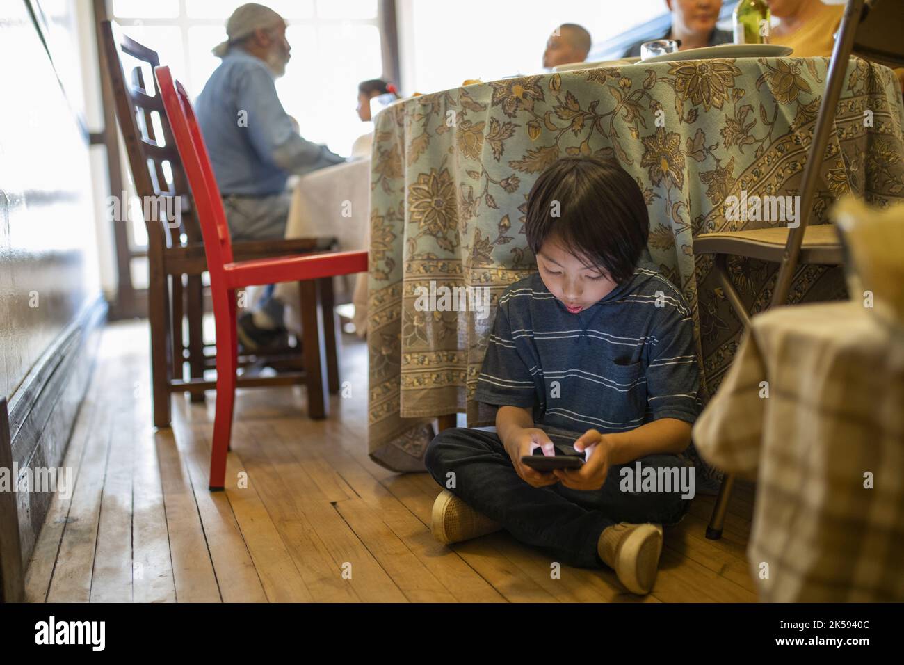 Boy sitting on the dining table hi-res stock photography and images - Alamy