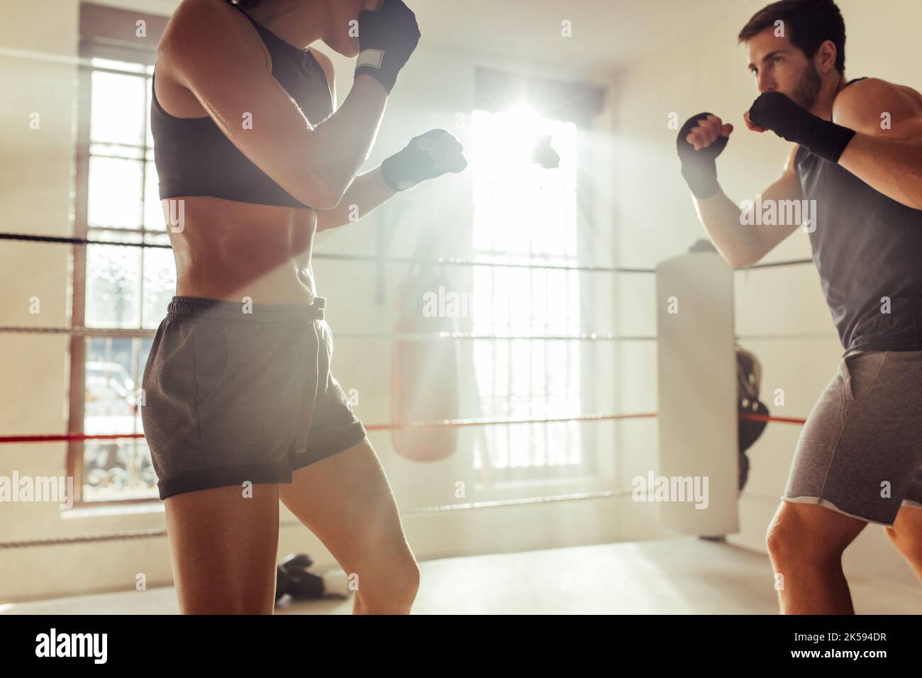 Two fighters facing each other in a boxing ring. Two young boxers ...