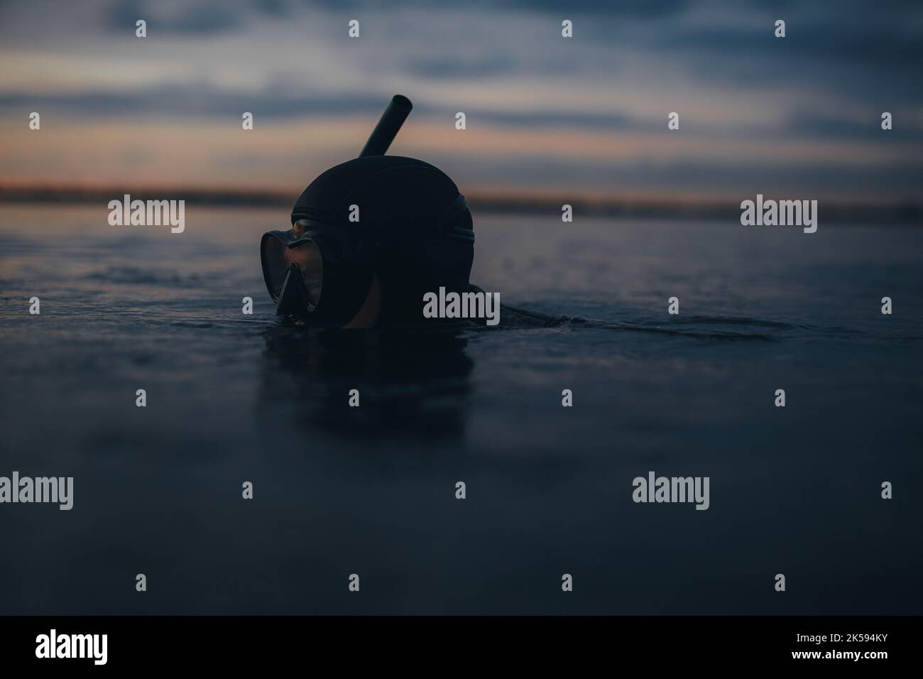 Person swimming in the ocean at sunset hi-res stock photography and ...