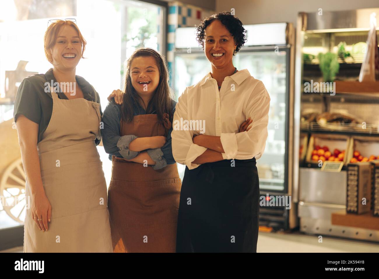 Group of diverse store workers smiling at the camera while standing ...