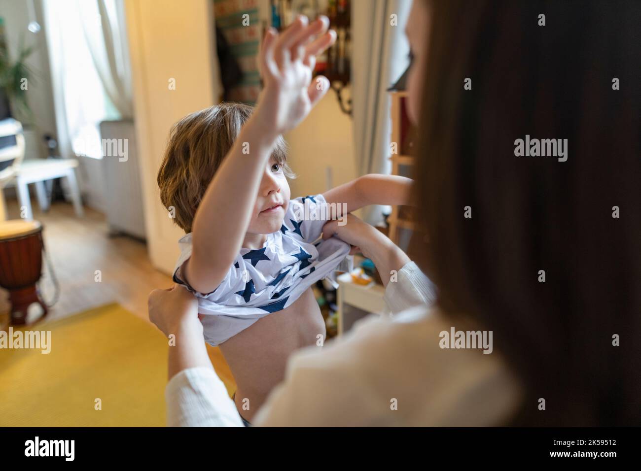 Child getting dressed hi-res stock photography and images - Alamy