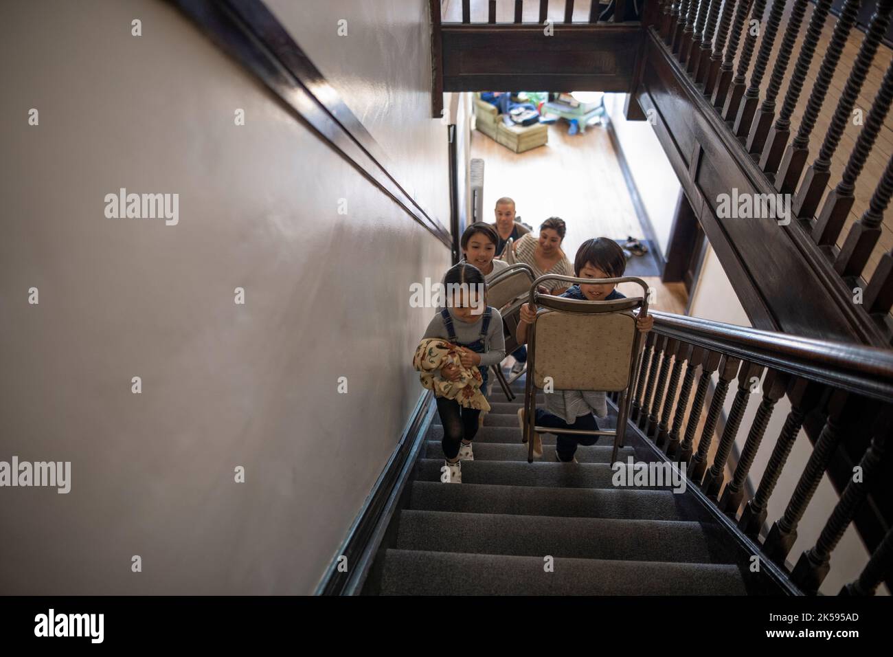 Boys carrying chairs hi-res stock photography and images - Alamy