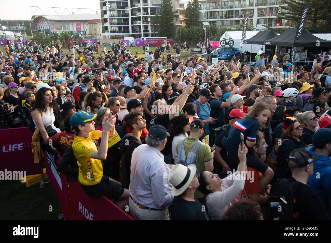 Thousands of fans crowd the podium after the finish of the elite men's ...