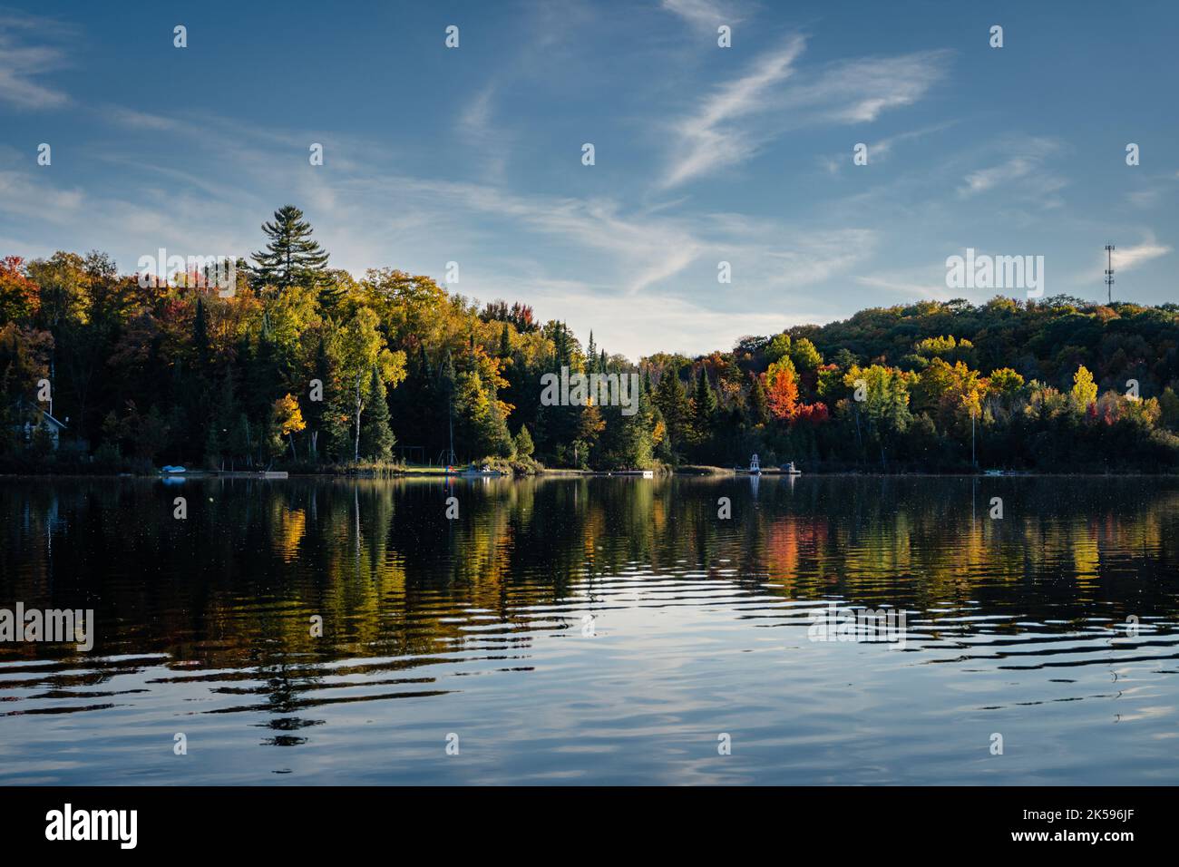 Cottage docks line the shore of this small peaceful lake Stock Photo ...