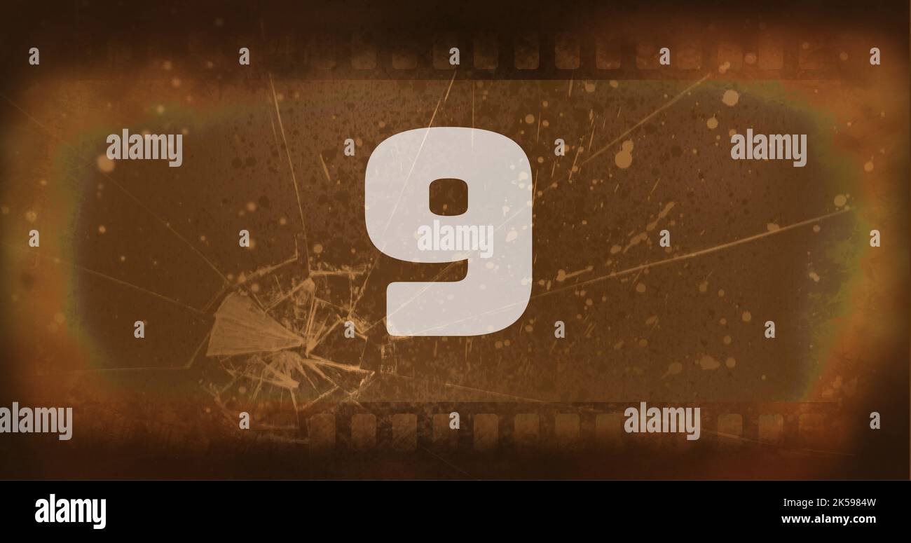 Composite of white colored number 9 text over scratched old negative ...