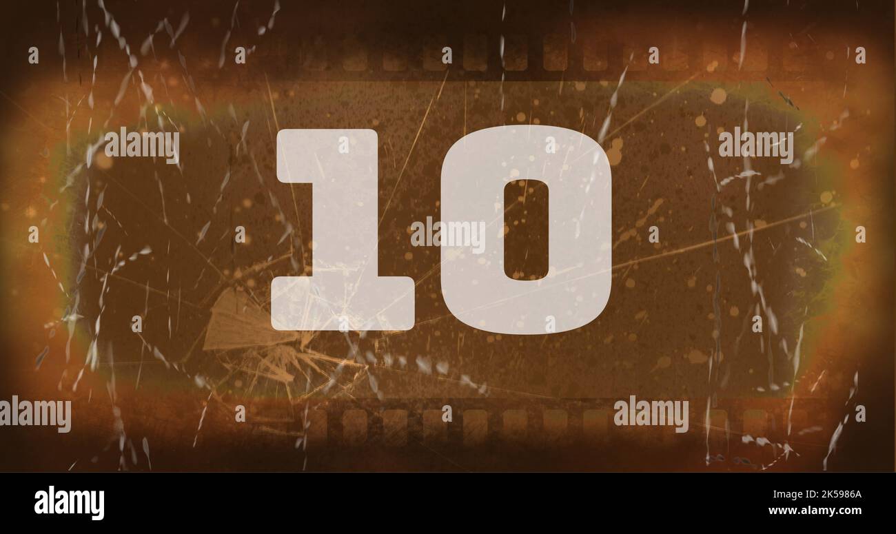 Composite of white colored number 10 text over scratched old negative ...