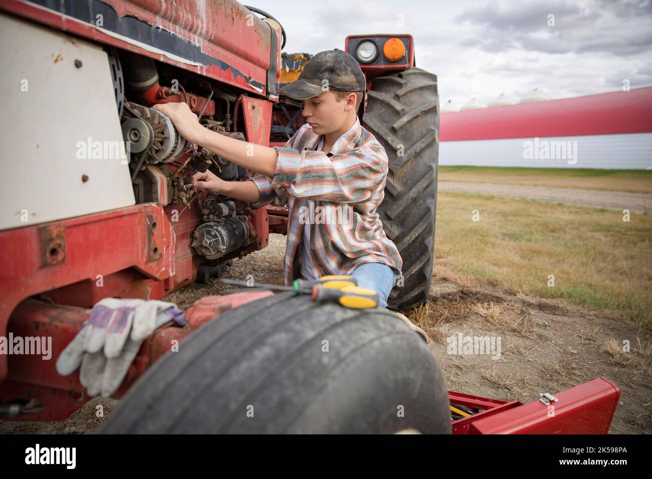 Boy fixing tractor hi-res stock photography and images - Alamy