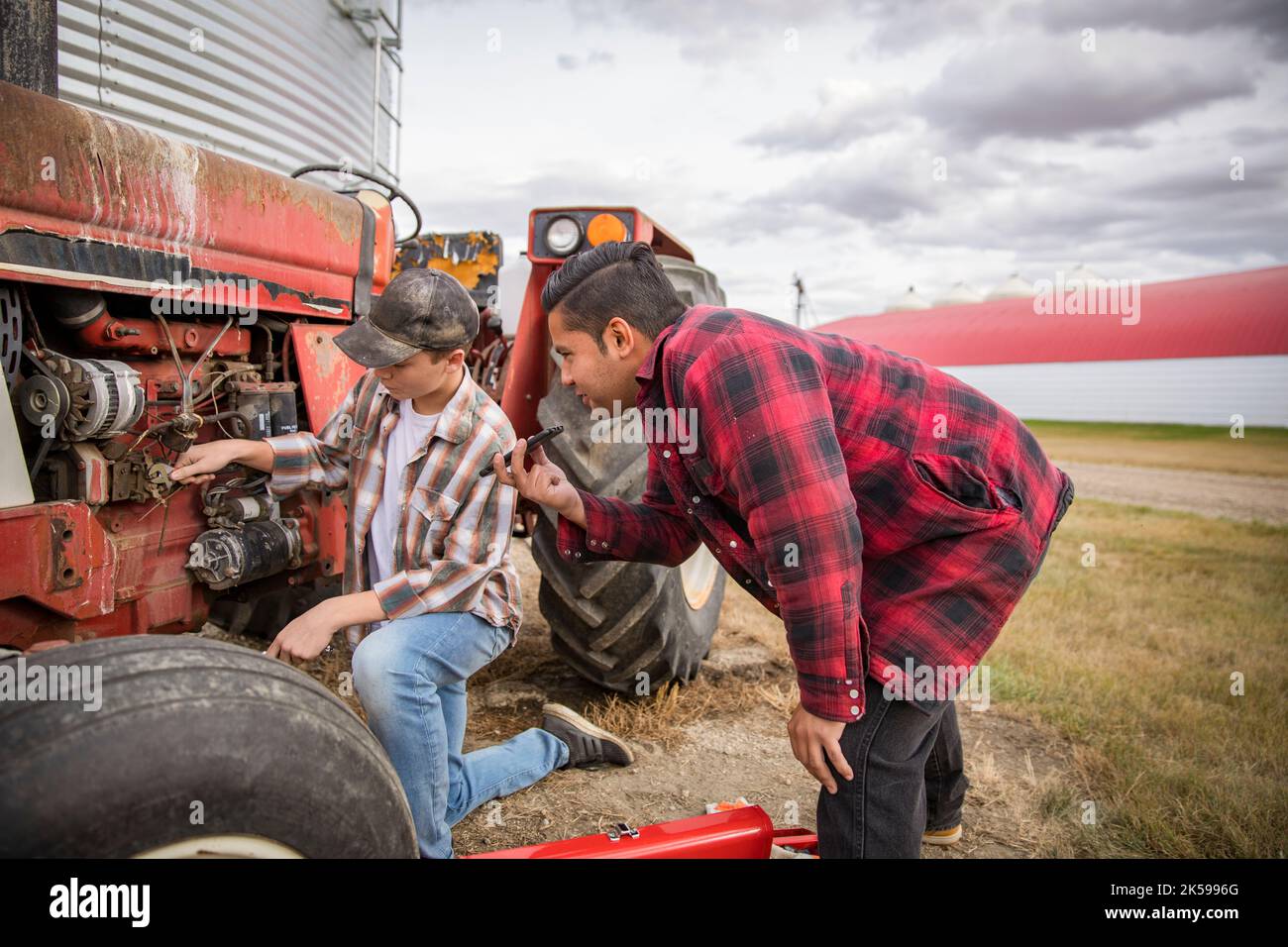 Boy fixing tractor hi-res stock photography and images - Alamy