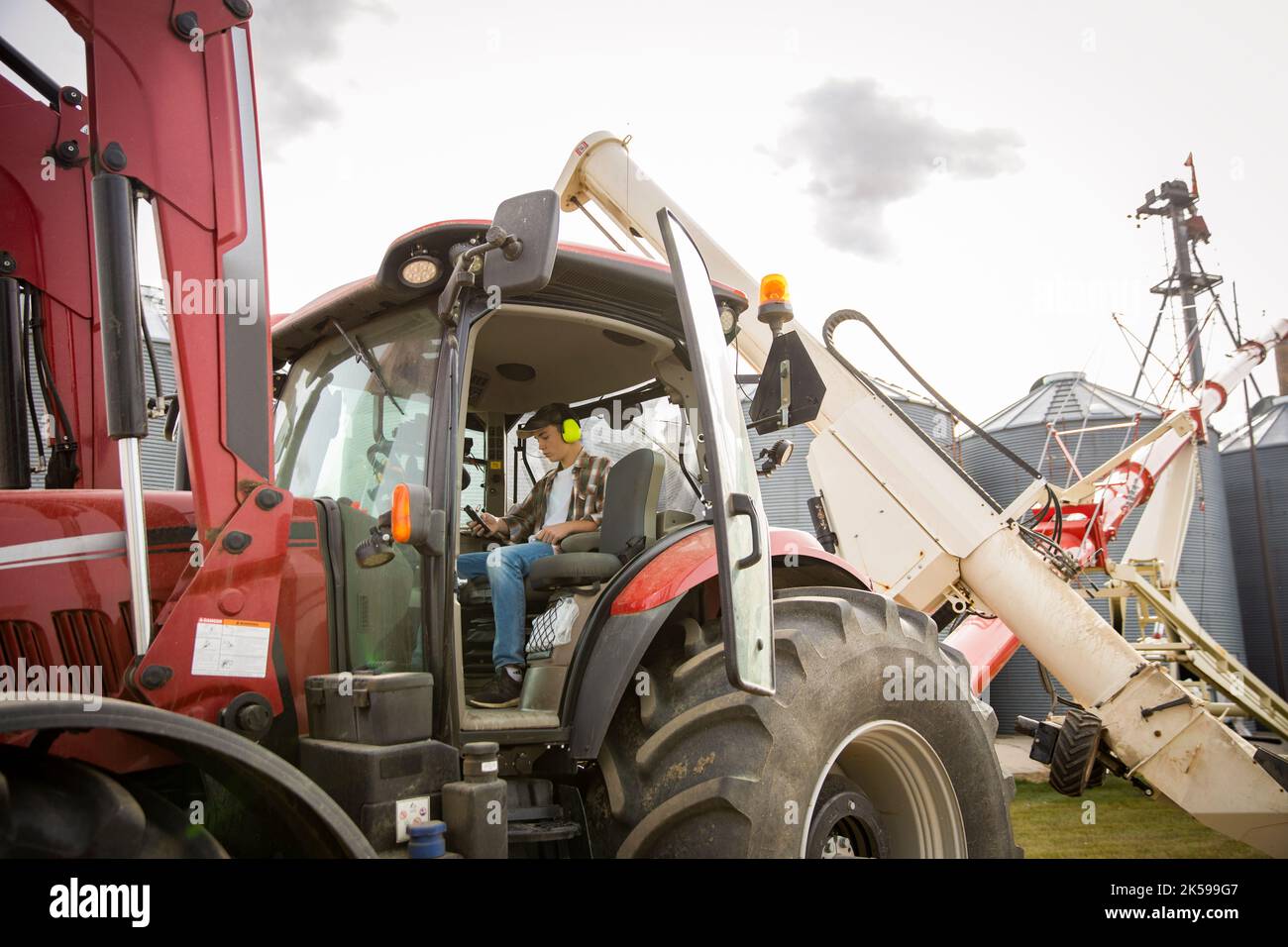 Farmer sitting on a tractor hi-res stock photography and images - Alamy