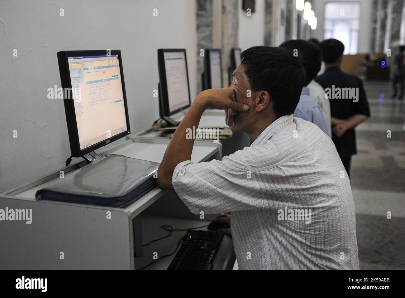 08.08.2012, North Korea, Pjoengjang - Men in front of computers use the ...