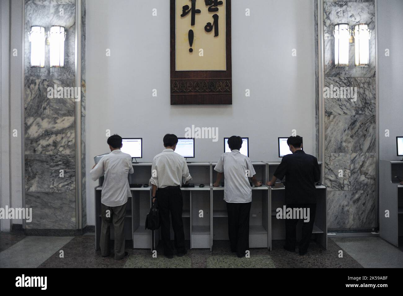 08.08.2012, North Korea, Pjoengjang - Men in front of computers use the ...