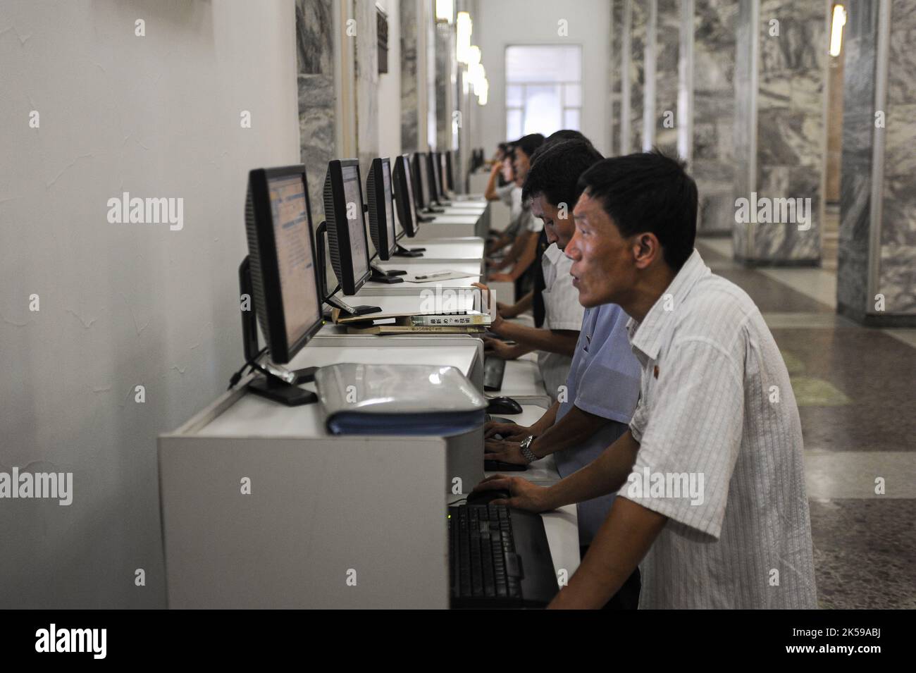 08.08.2012, North Korea, Pjoengjang - Men in front of computers use the ...