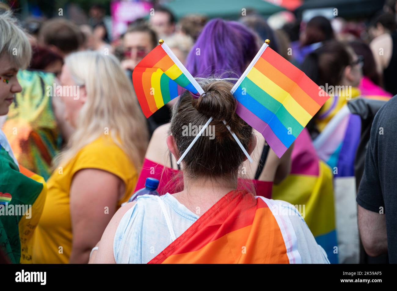 23.07.2022, Germany, Berlin - A participant with colorful rainbow ...