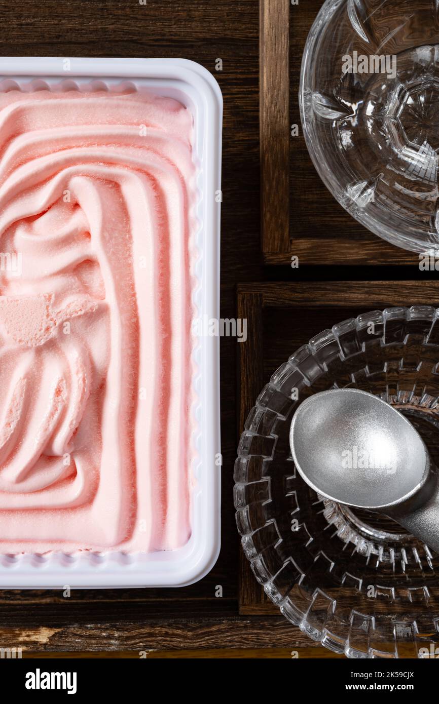 top view box of strawberry flavor ice cream with scoop and bowls ...