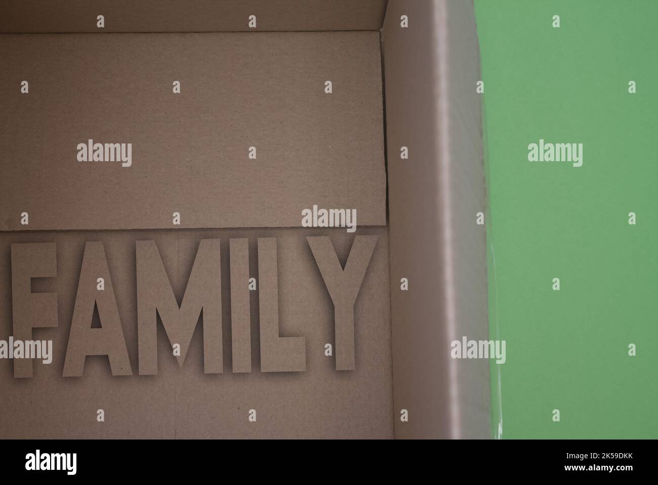 Family word with cardboard box. Brown folded card box Stock Photo - Alamy