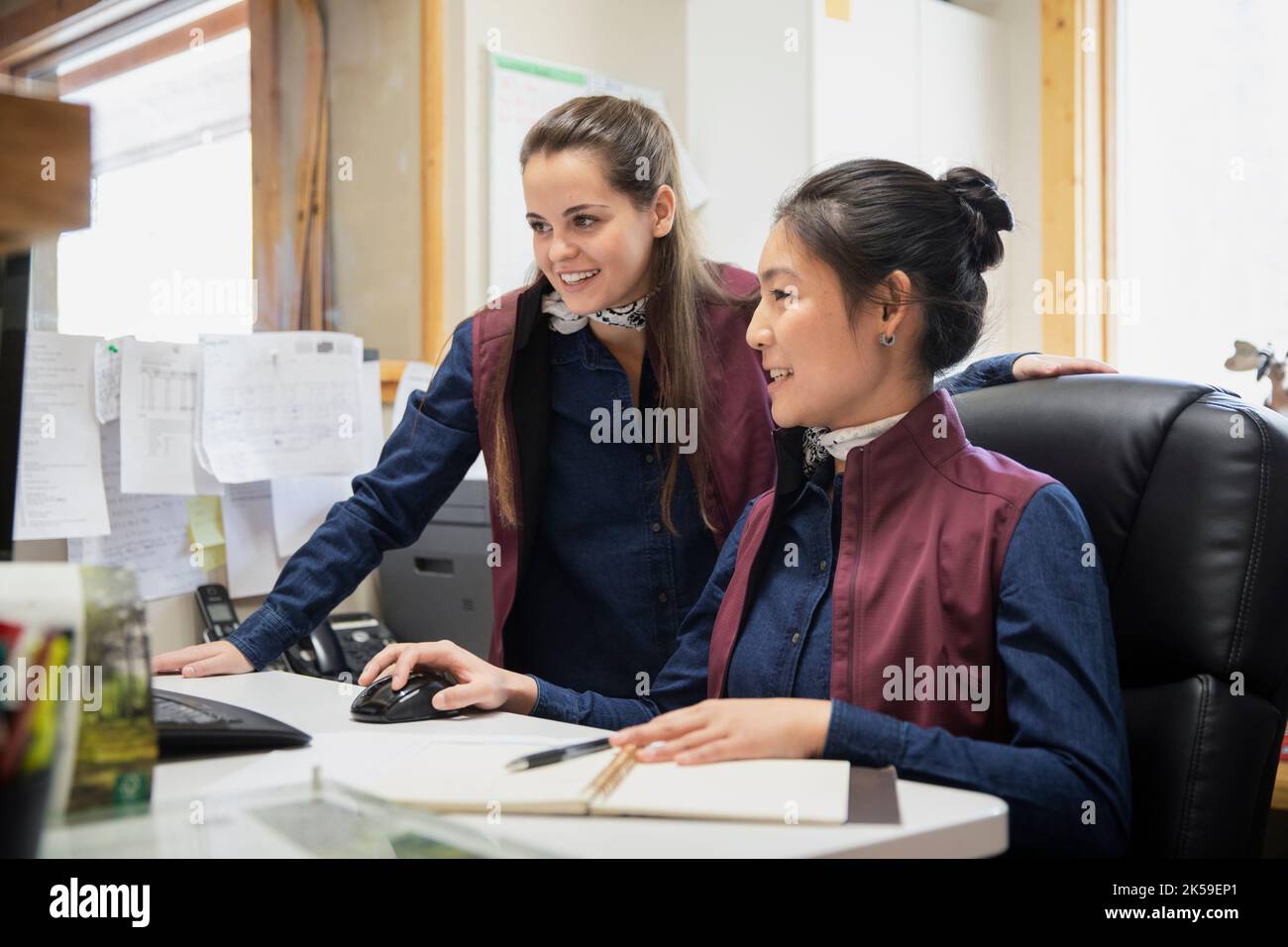 Female employee sitting desk hi-res stock photography and images - Alamy