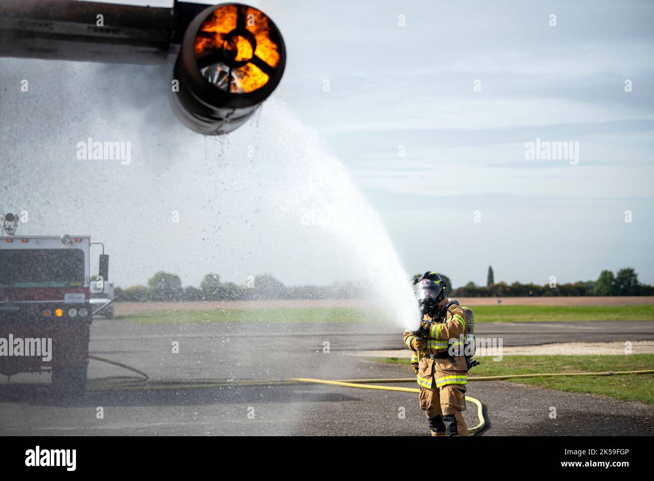 A firefighter from the 422d Fire Emergency Services extinguishes an ...