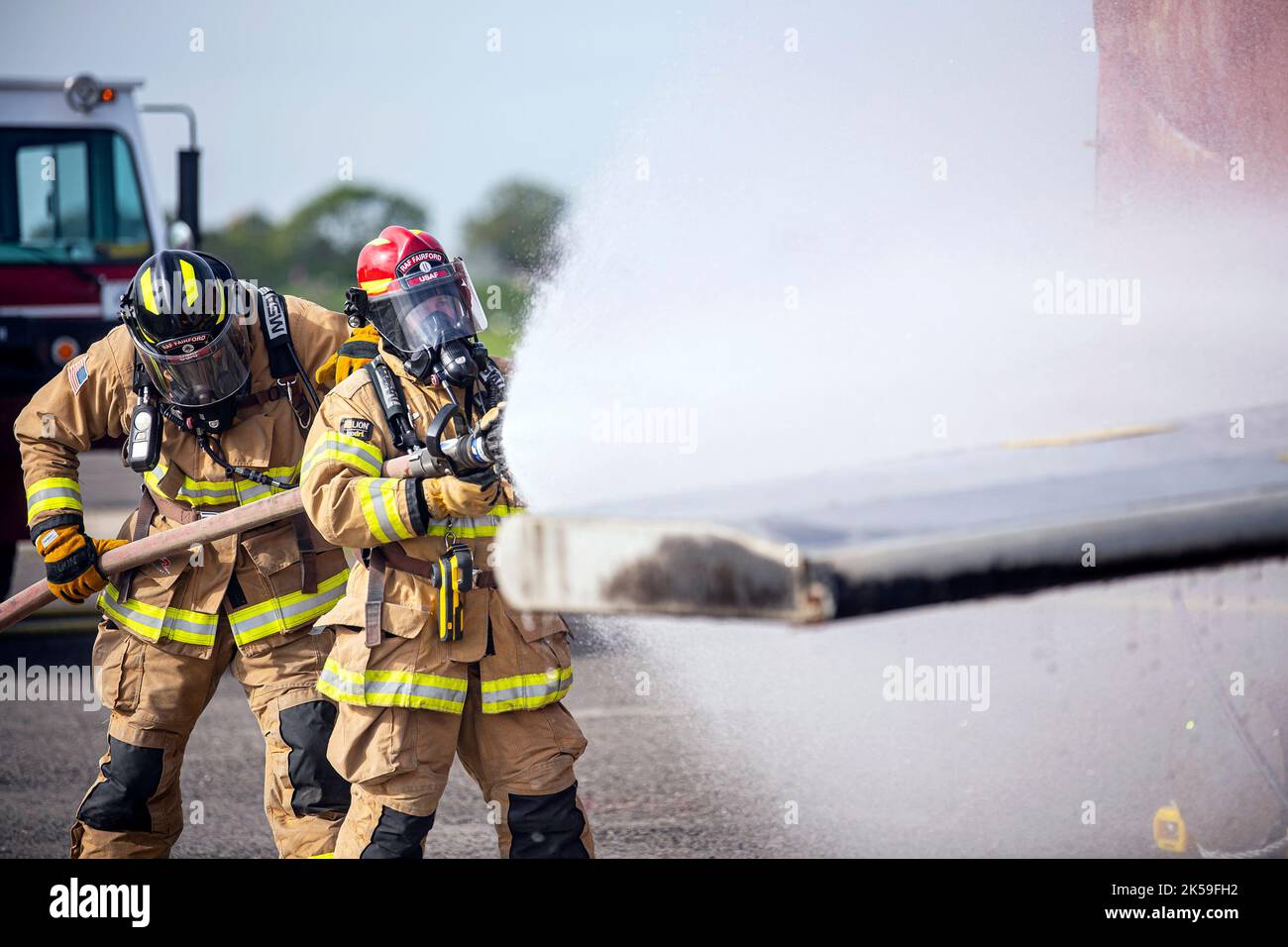Firefighters from the 422d Fire Emergency Services extinguish an ...