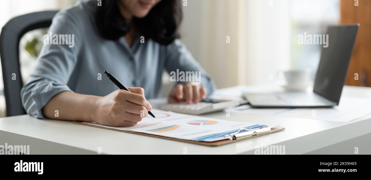 Business people or accountants are analyzing graphs on finance report ...