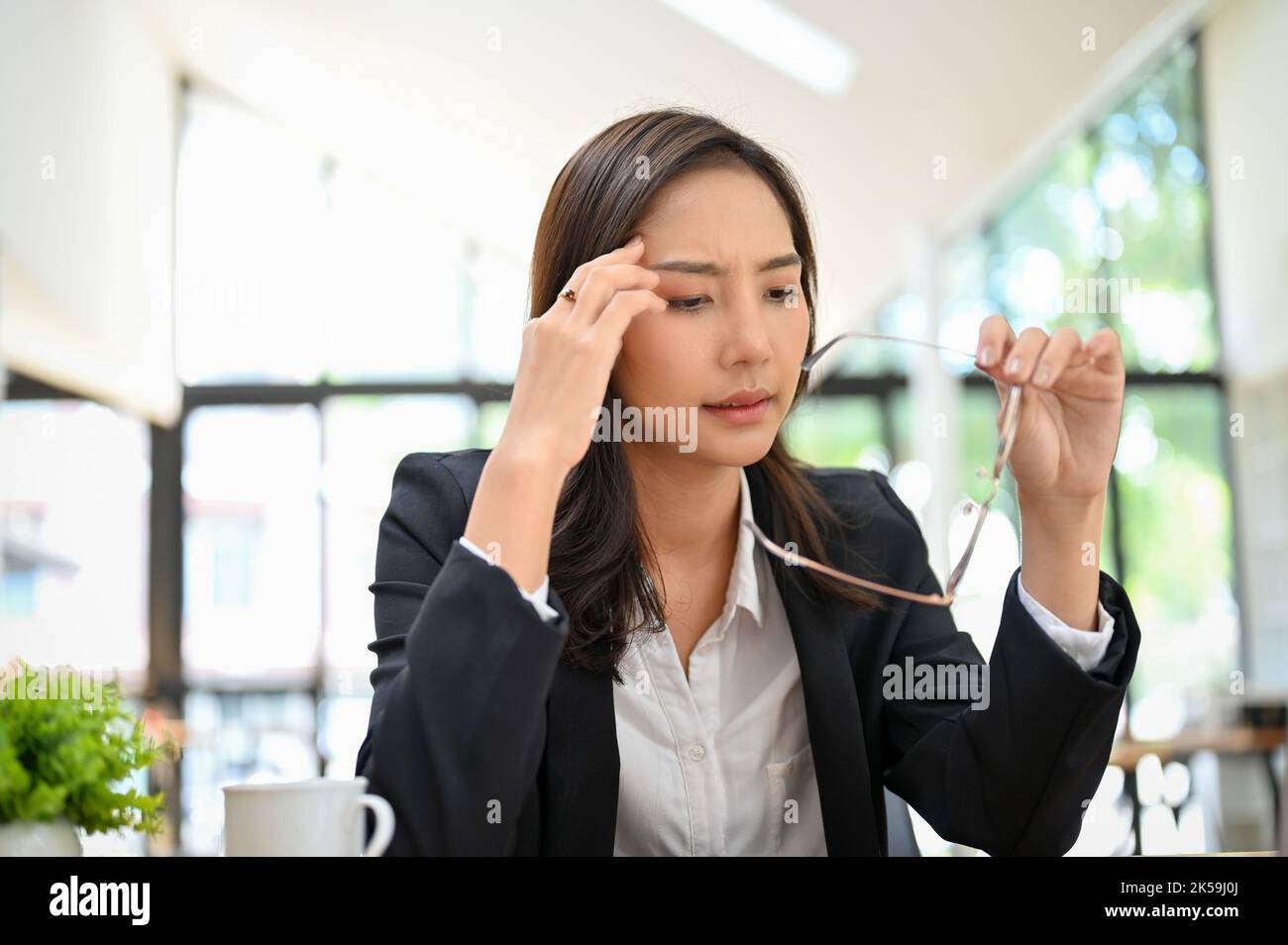 Tired and overworked millennial Asian businesswoman or female office ...