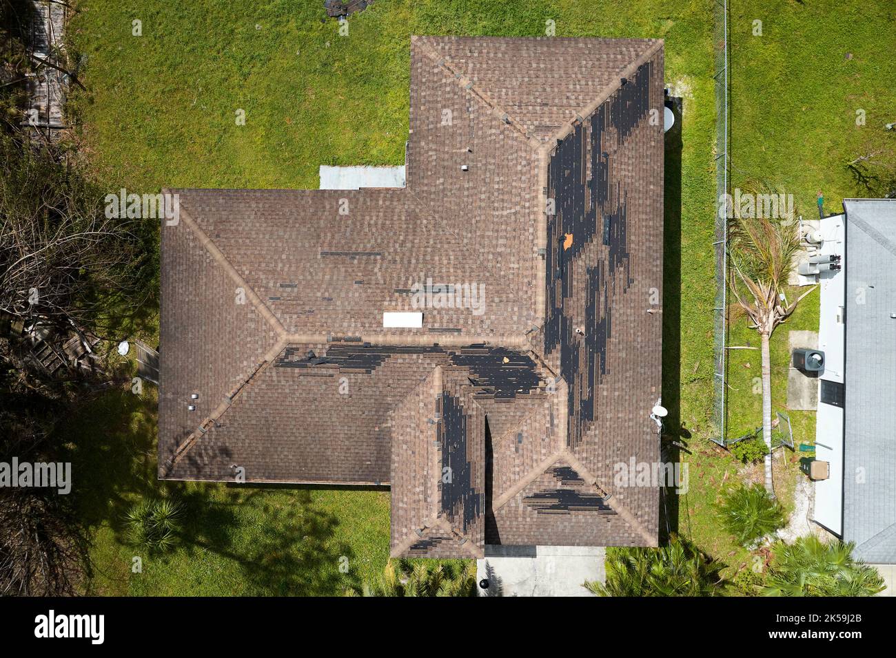Hurricane Ian destroyed house roof in Florida residential area. Natural ...