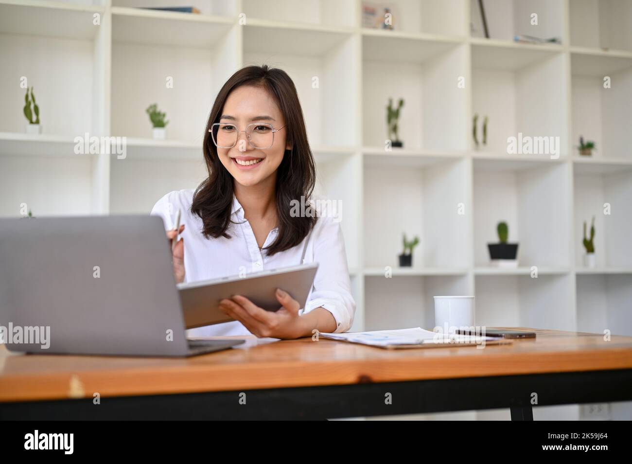 Pretty and charming young Asian businesswoman or female marketing ...