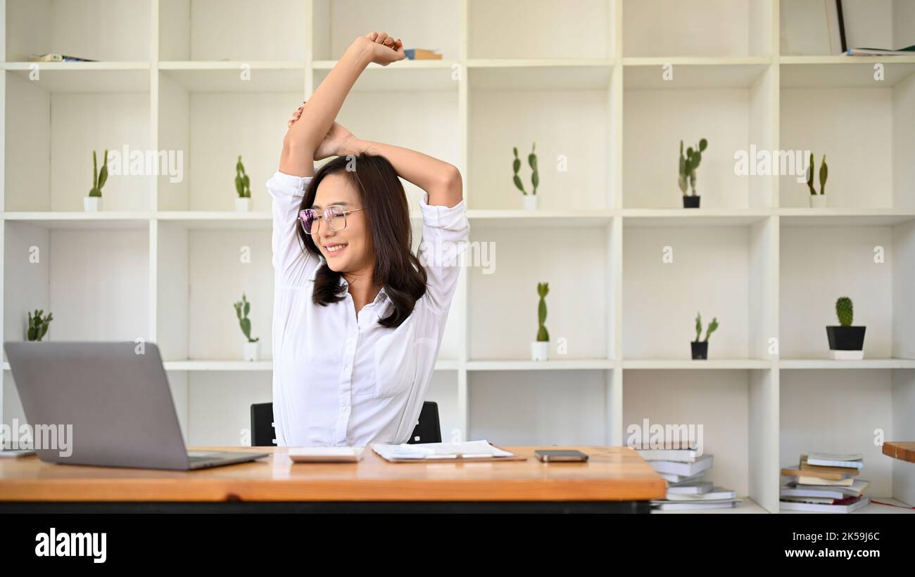 Beautiful young Asian businesswoman or female office employee relaxing ...