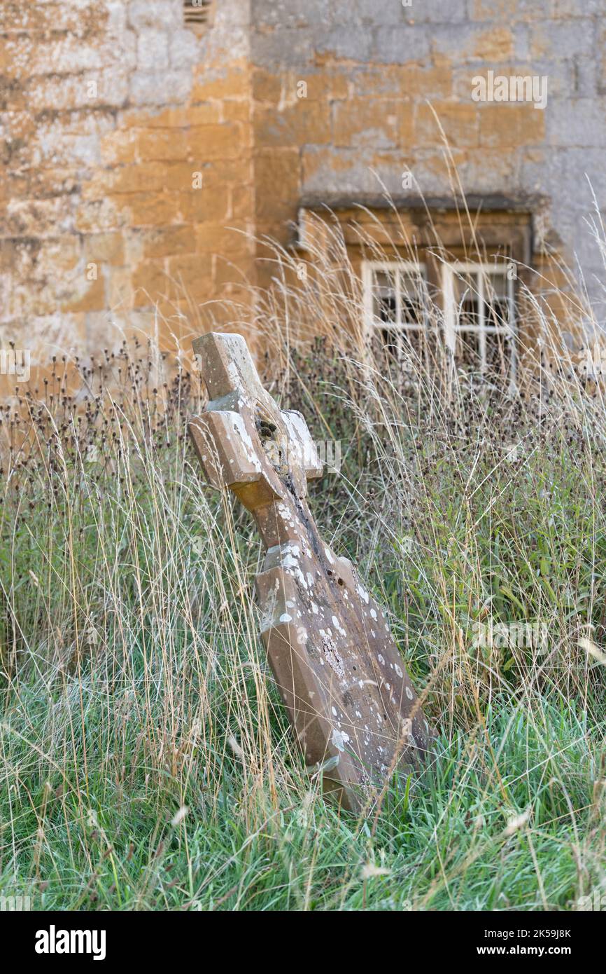 Old grave stone in the long grass at St Peter & St Paul Churchyard ...