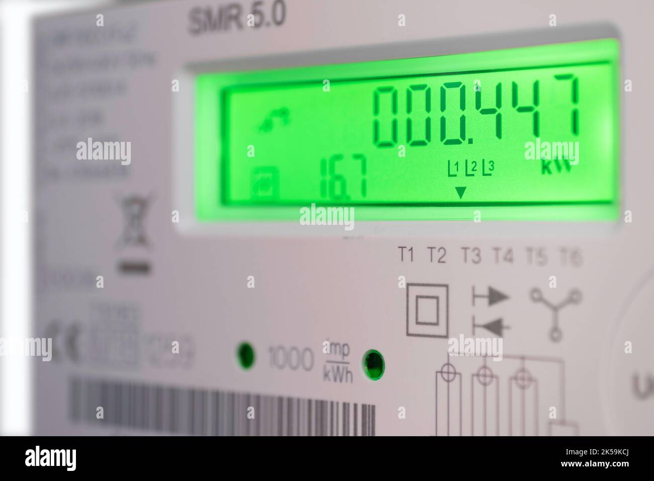 Modern smart electricity meter with green display in a Dutch household ...