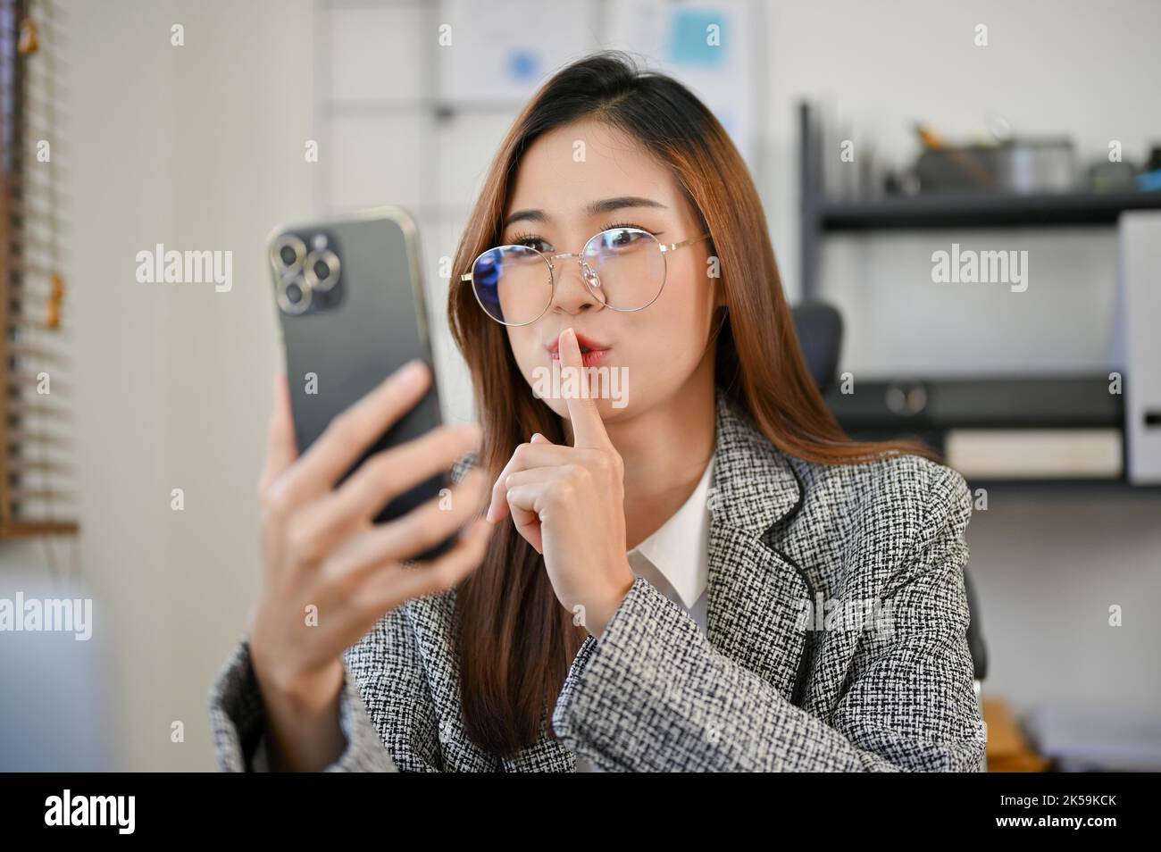 Joyful and happy young Asian businesswoman is having a video call on ...