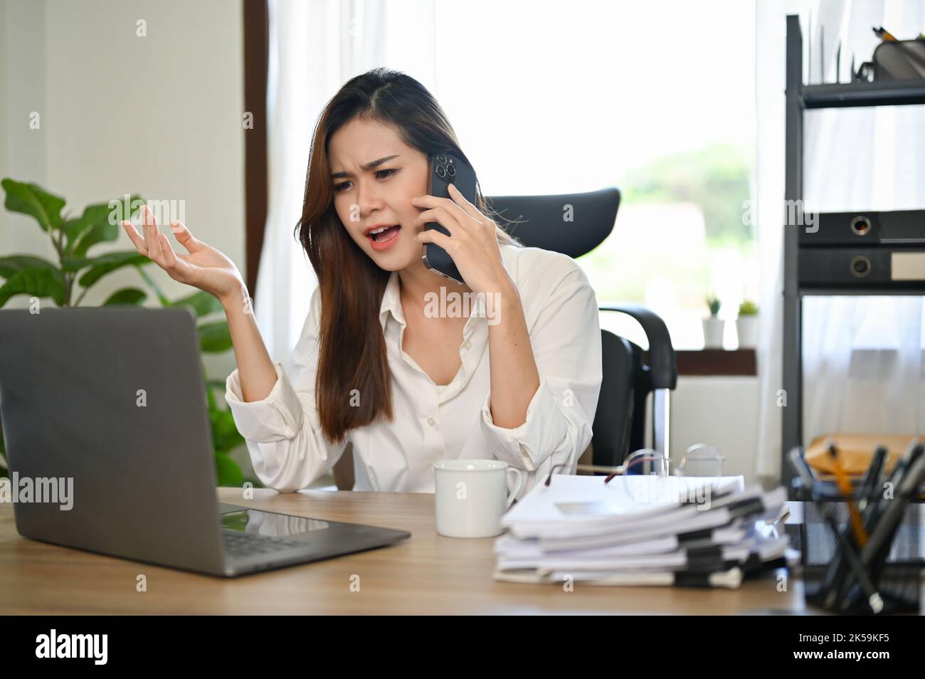 Angered and unsatisfied millennial Asian businesswoman or female boss ...