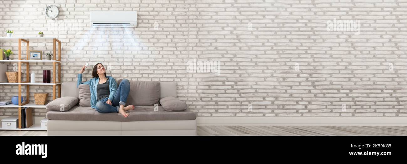 Air Conditioner In House. Woman Relaxing Under Conditioning System ...